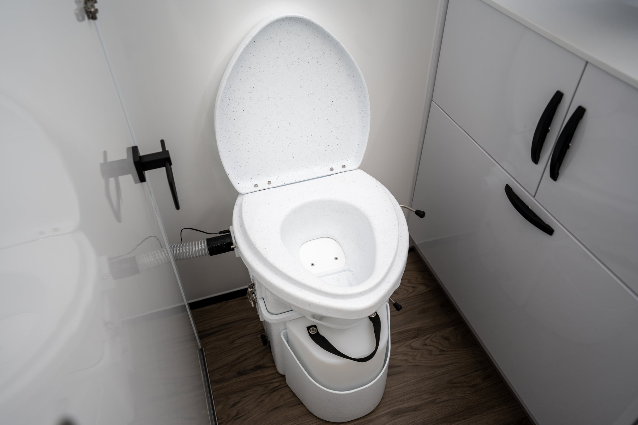 How does the composting toilet work without water?